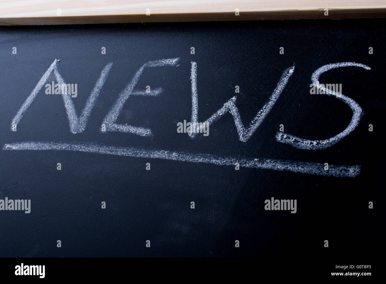 News written on a blackboard on a white background Stock Photo - Alamy