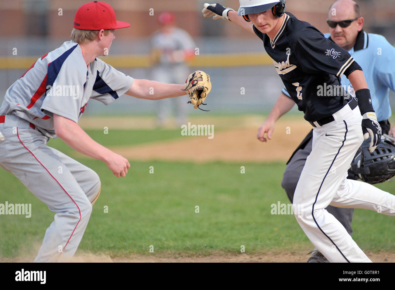 While caught in a rundown between home and third base a runner is about ...