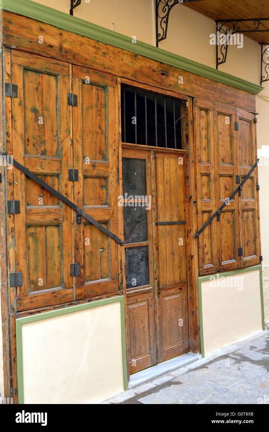 Door with two wooden windows with two shutters in arc of brown color ...