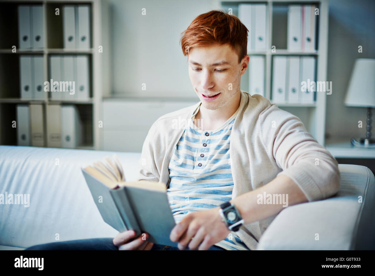Happy student guy reading hi-res stock photography and images - Alamy