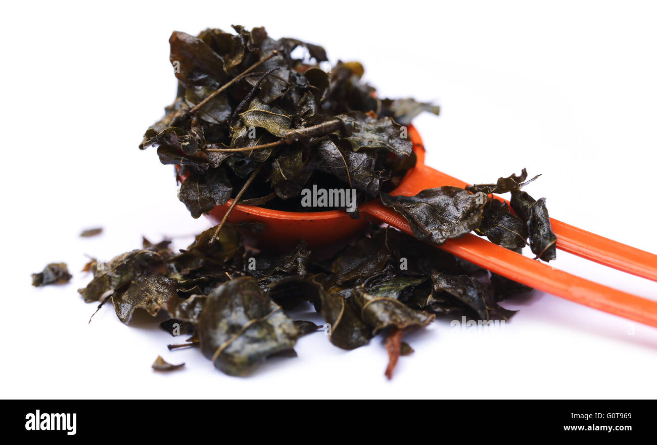 Fried moringa leaves in a spoon over white background Stock Photo - Alamy