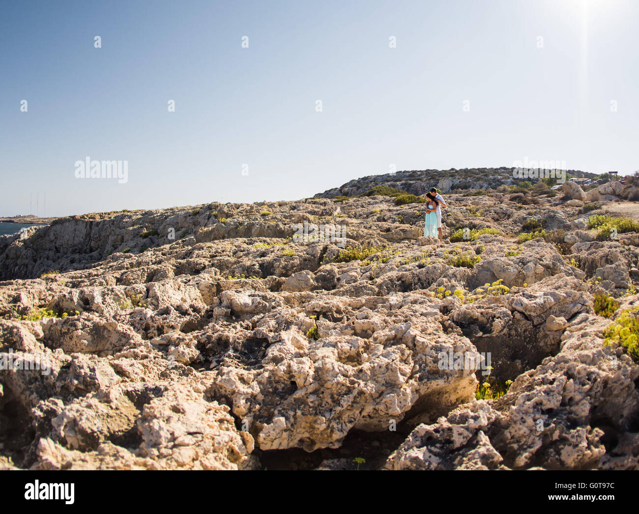 beautiful couple embrace on a stones Stock Photo - Alamy