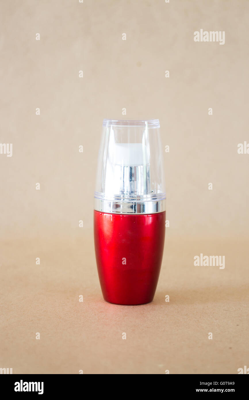 Shiny hard red bottle on brown background, stock photo Stock Photo - Alamy