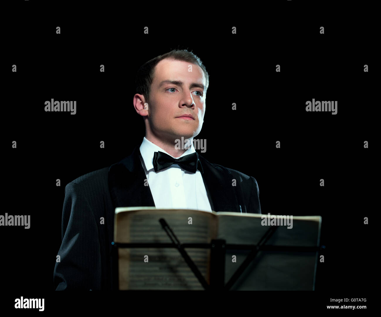 Studio image of young man conducts the orchestra Stock Photo - Alamy