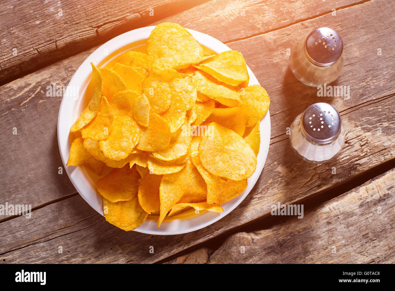 Chips with salt and pepperbox Stock Photo - Alamy