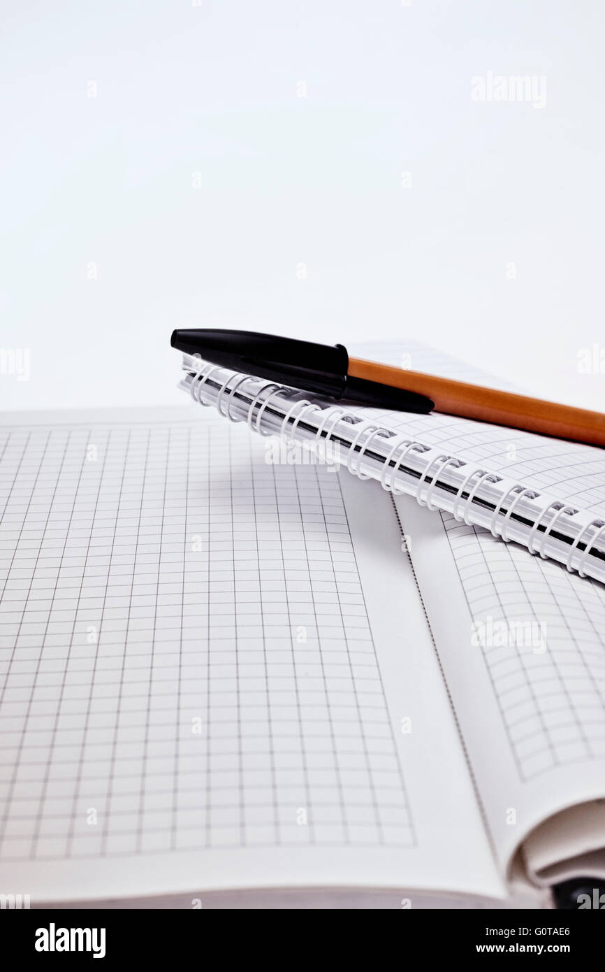 Yellow ballpen and two notebook closeup Stock Photo - Alamy