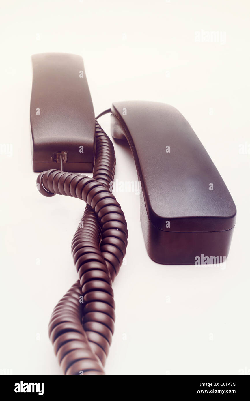 Black telephone receiver with cable on white background Stock Photo - Alamy