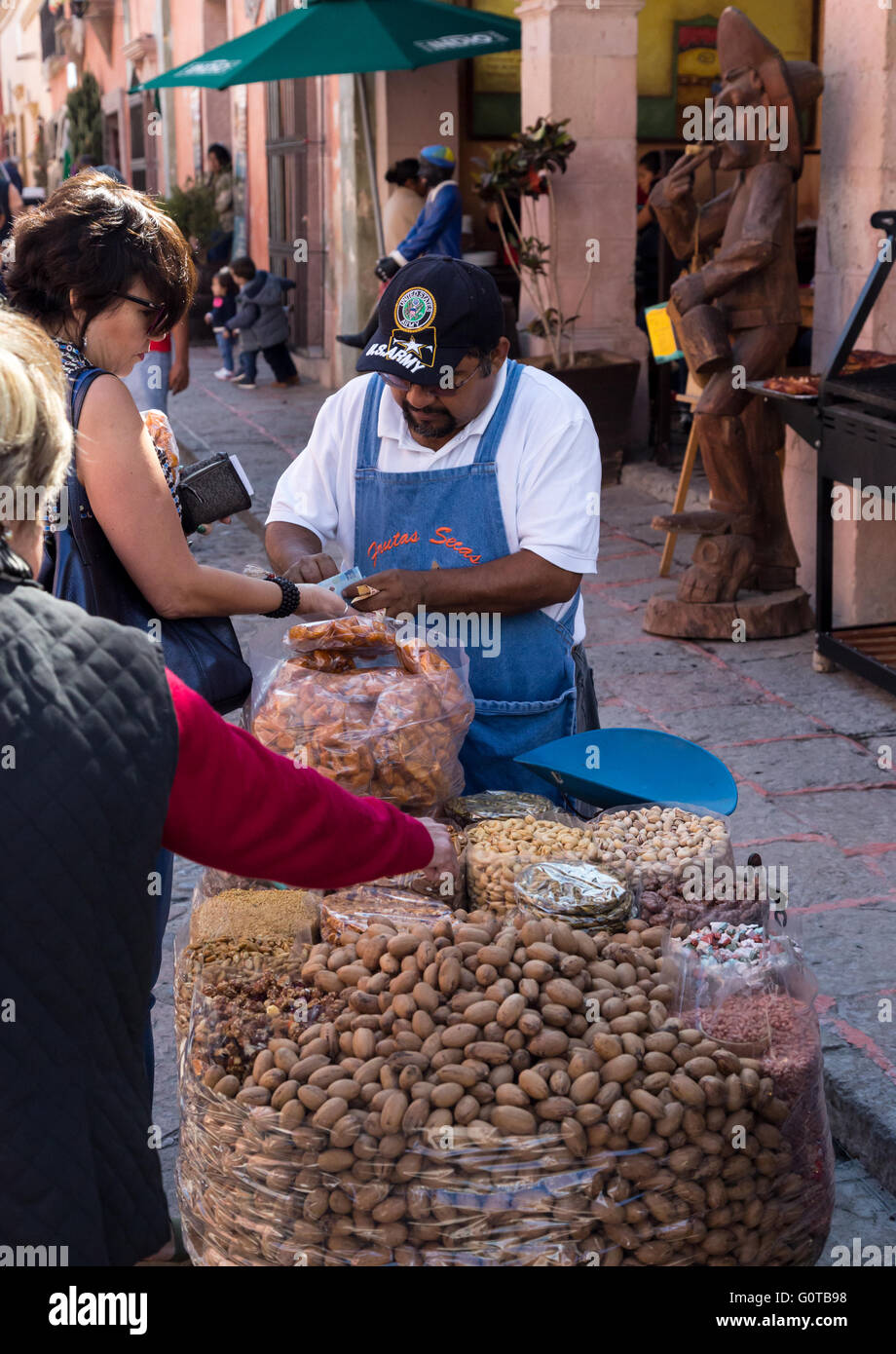 Mexican man selling various nuts in Pueblo Magico of Bernal, a small ...