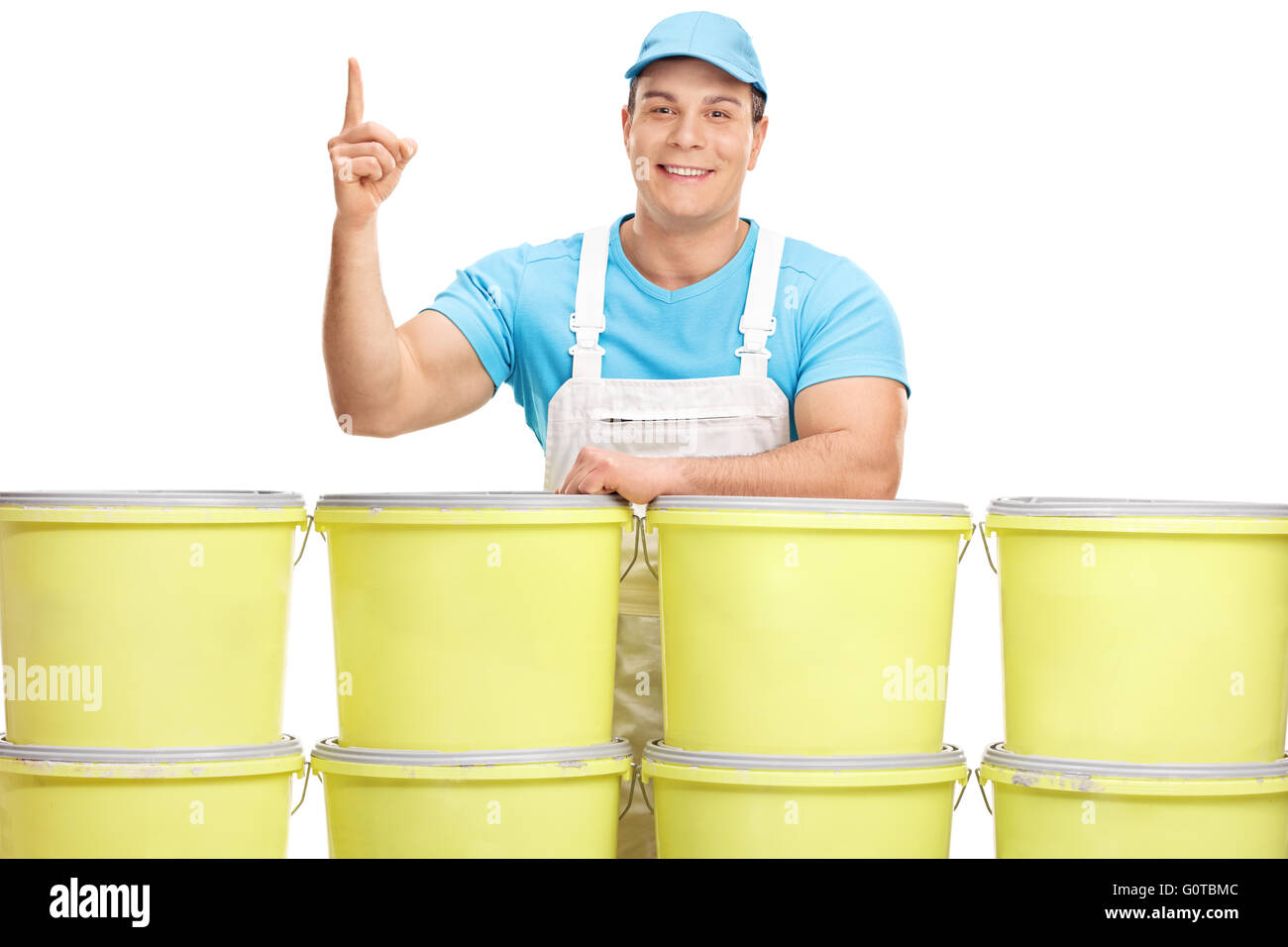 Male decorator pointing up with his finger and standing behind a bunch ...