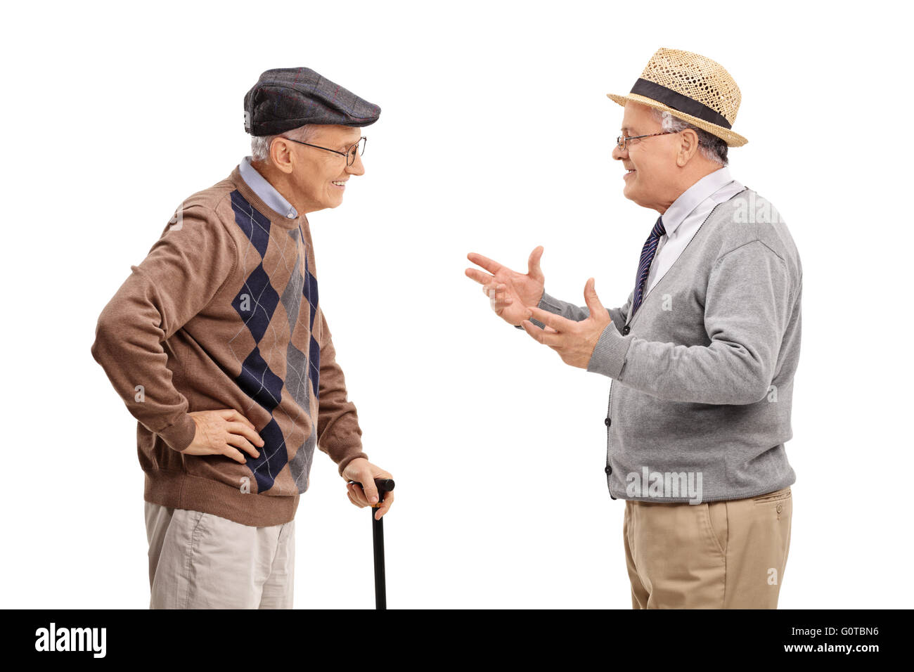 Two senior gentlemen talking to each other and smiling isolated on ...