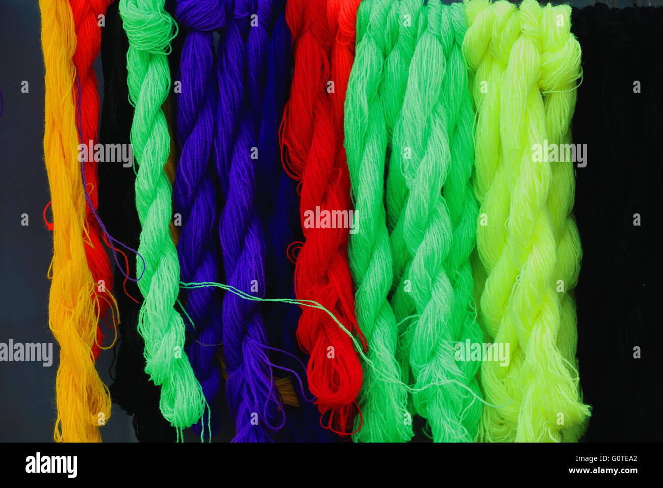 Multicolored cords of plastic yarn braided together as to form solid ...