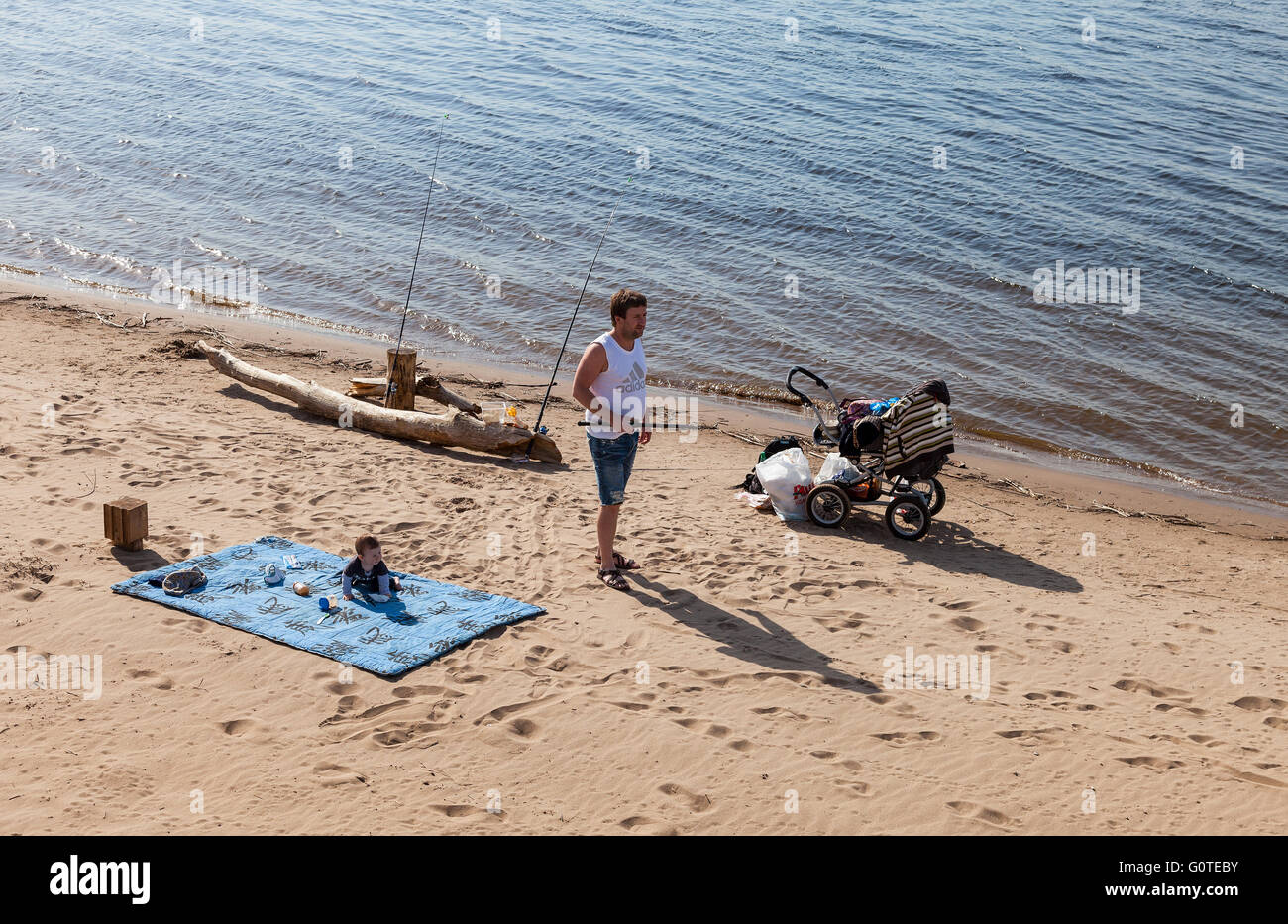 Man with the child fishing on the fishing rod on the bank of the Volga ...