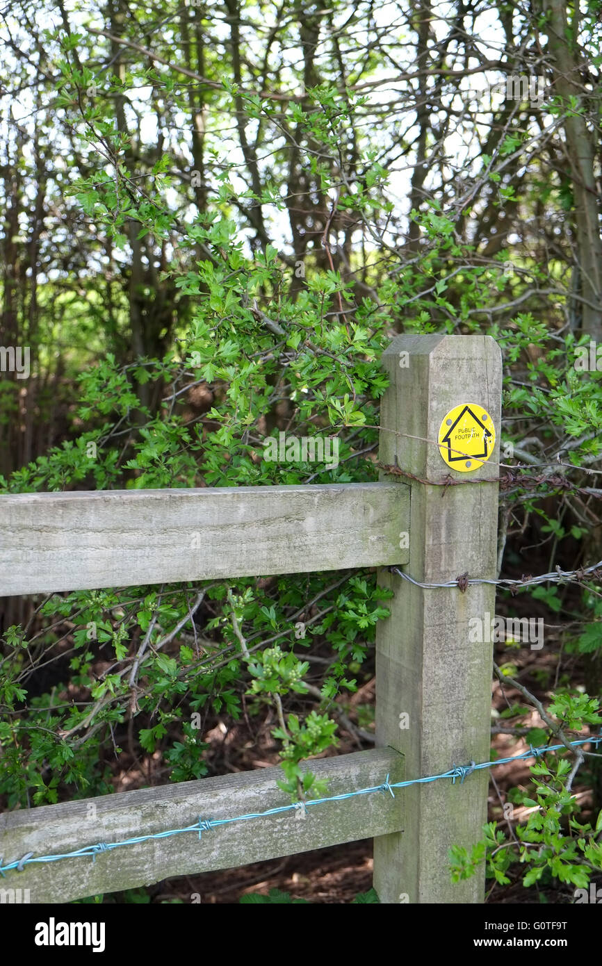 Stile on a British Public Footpath complete with yellow sign and barbed ...