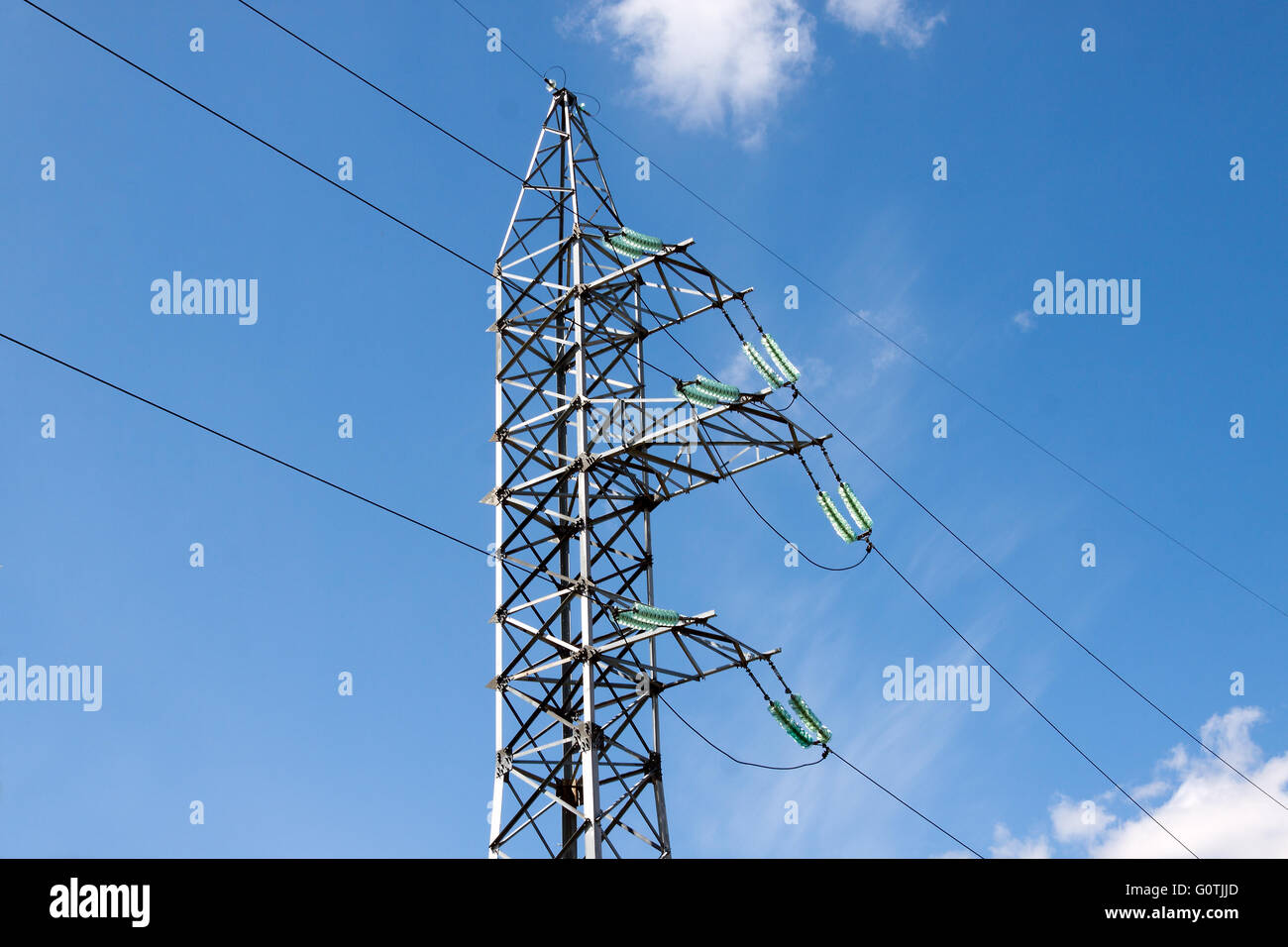 Electric pylon against the backdrop of the blue sky on a summer day ...