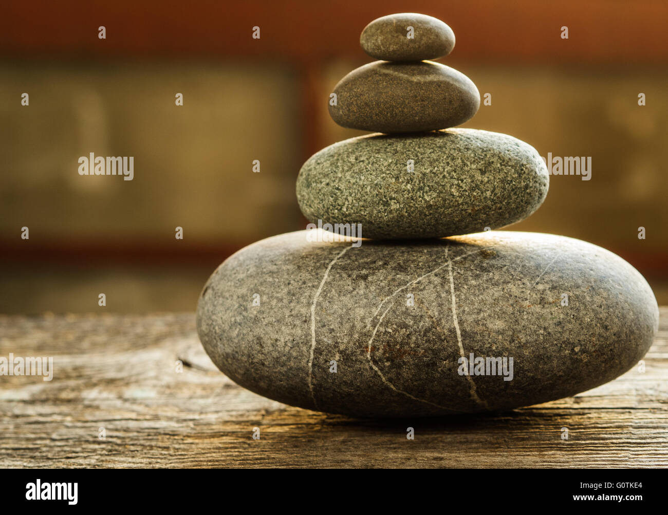 Four rocks balancing on top of each other on wooden deck Stock Photo ...