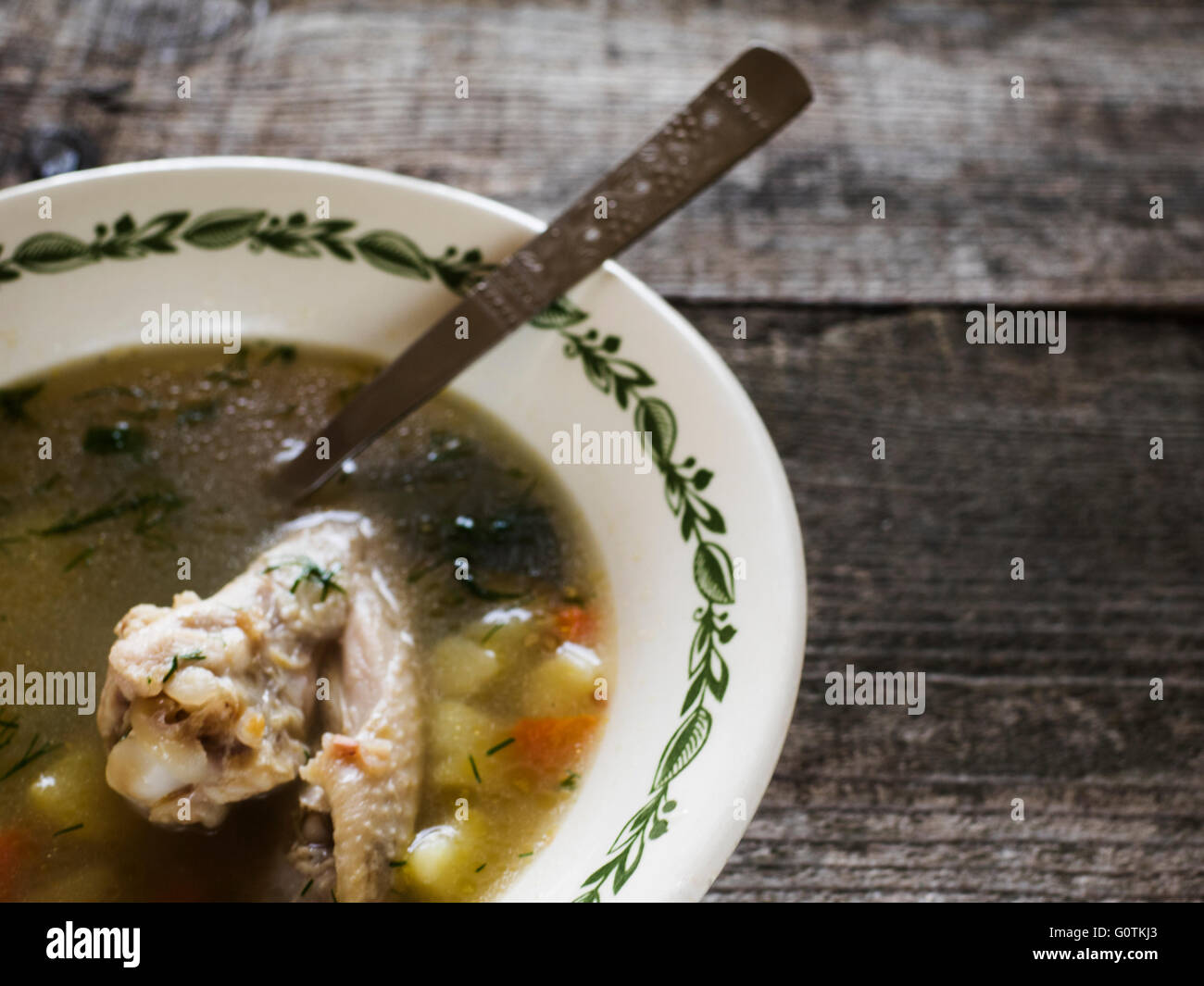 Bowl of chicken soup on wooden table Stock Photo - Alamy