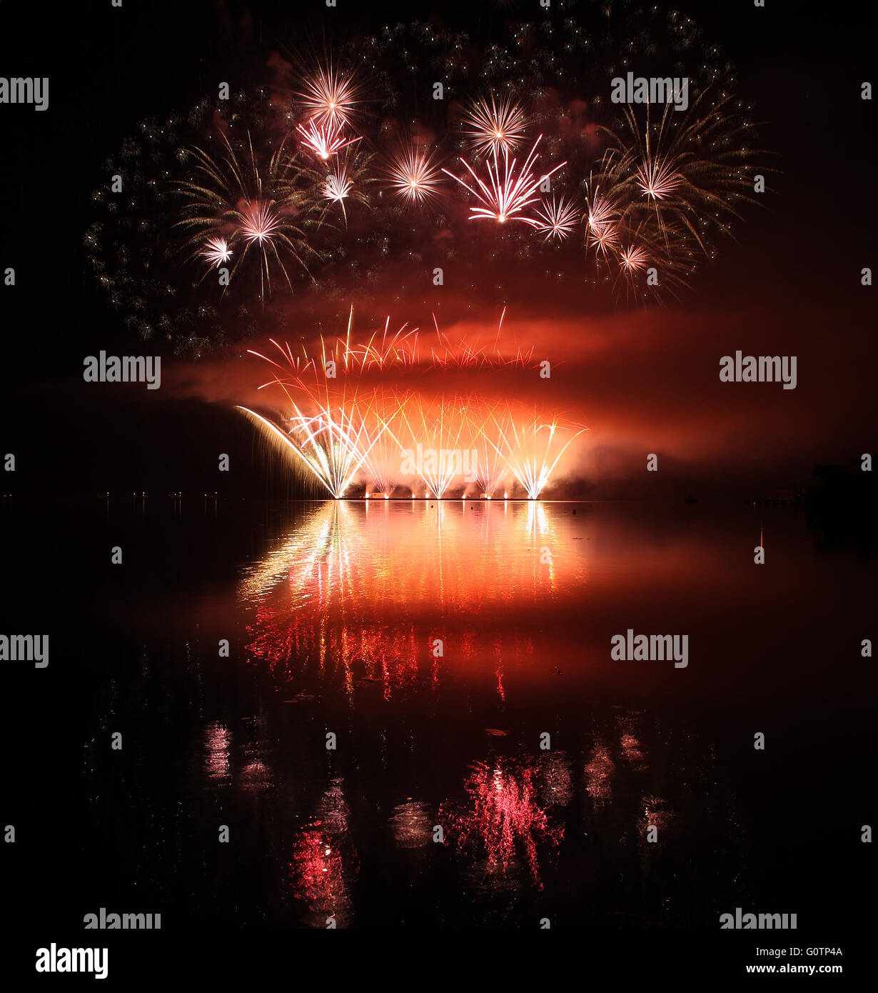 Colorful fireworks with reflection on lake and night sky in background ...