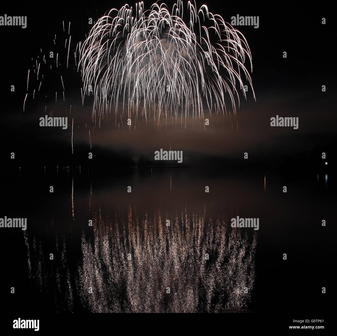 Colorful fireworks with reflection on lake and night sky in background ...