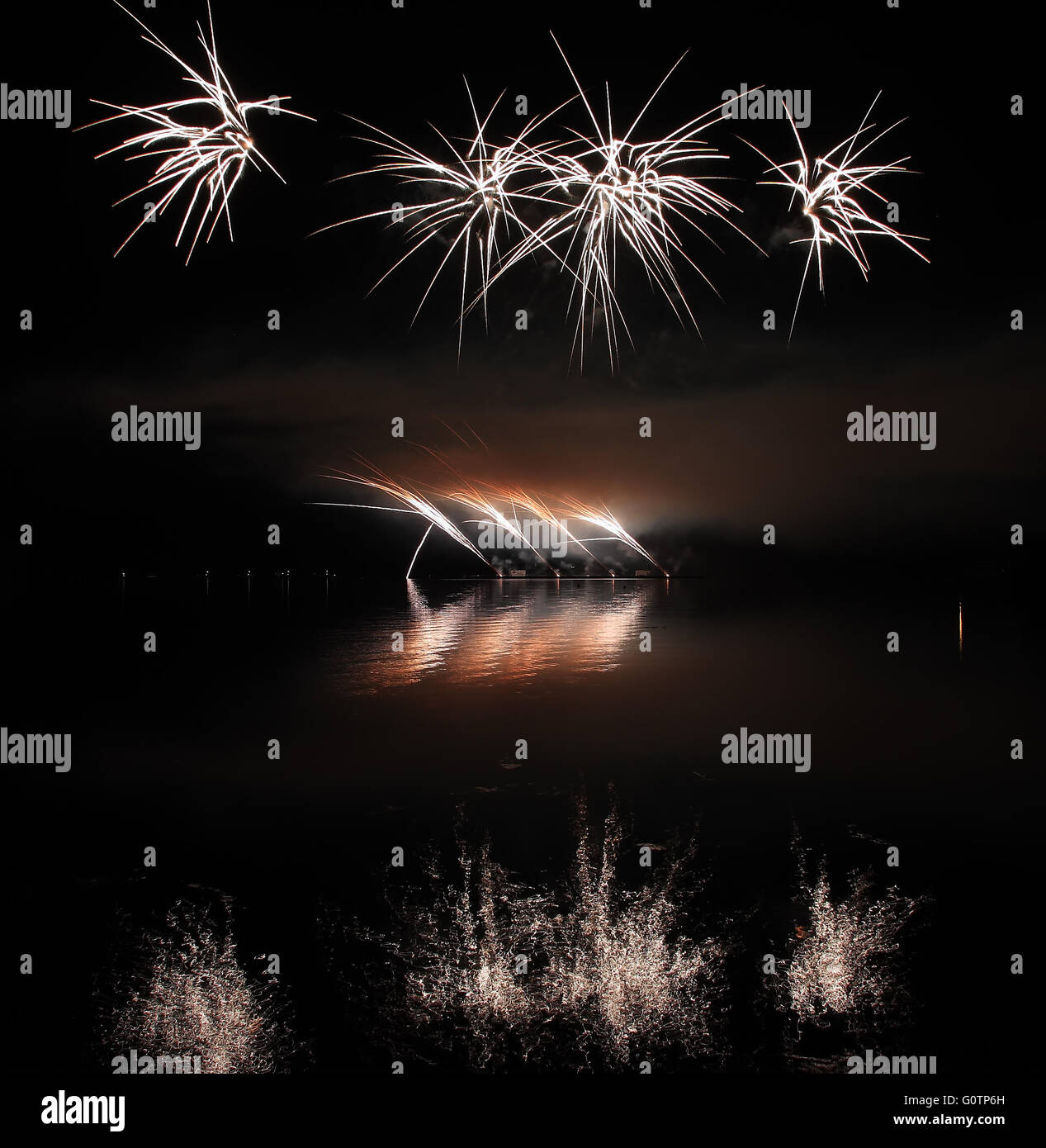 Colorful fireworks with reflection on lake and night sky in background ...