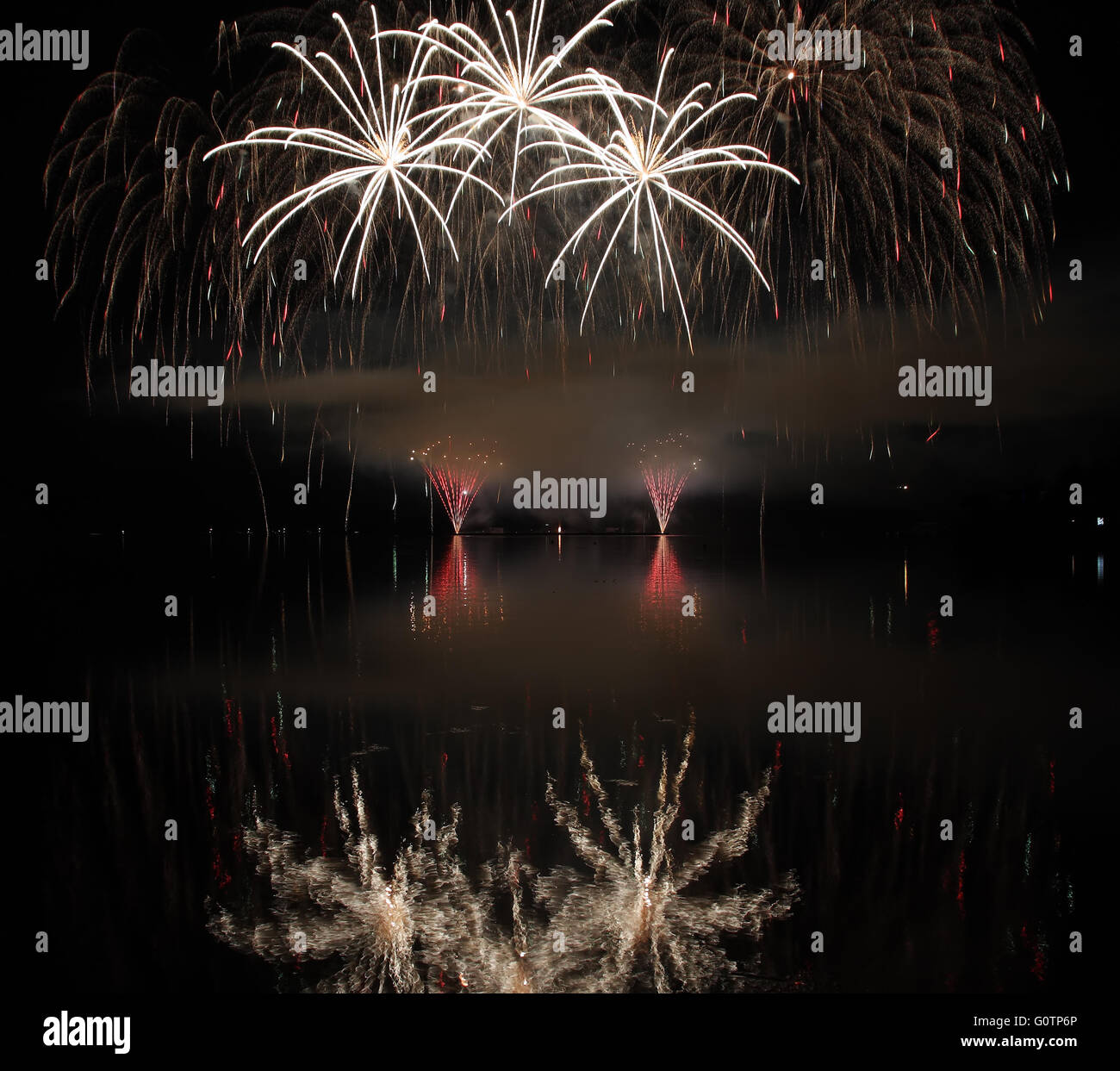 Colorful fireworks with reflection on lake and night sky in background ...