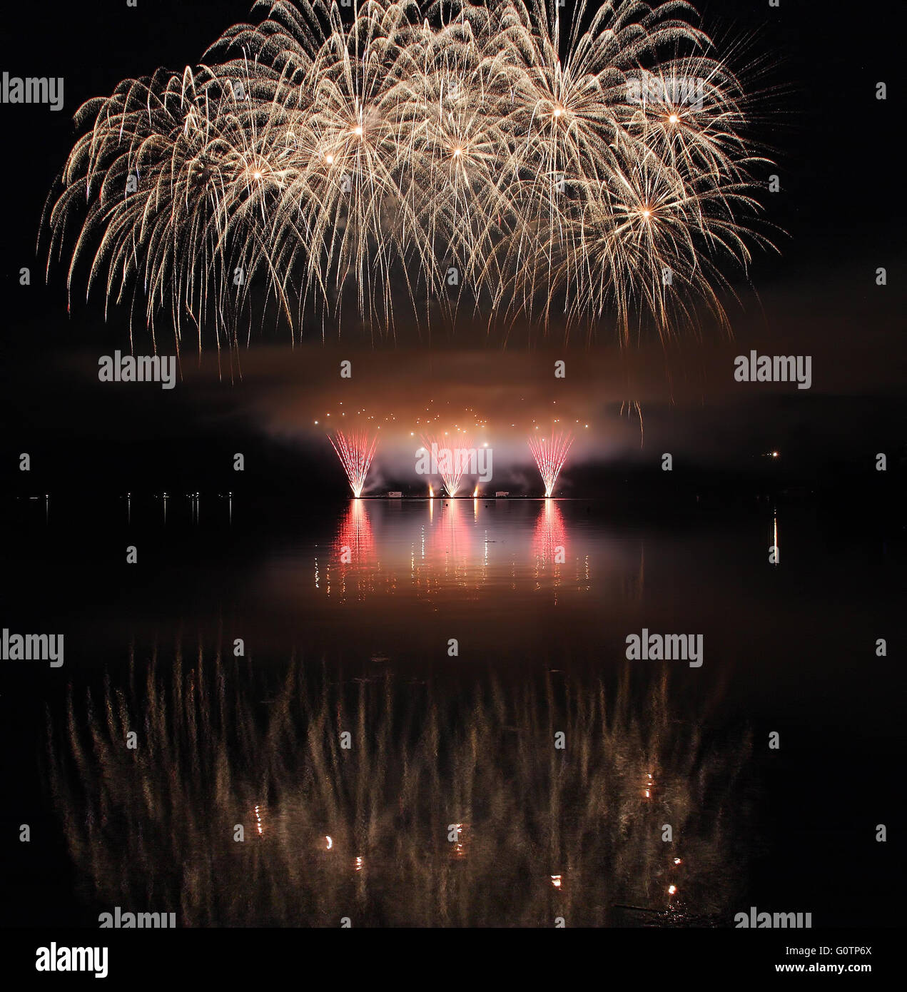 Colorful fireworks with reflection on lake and night sky in background ...