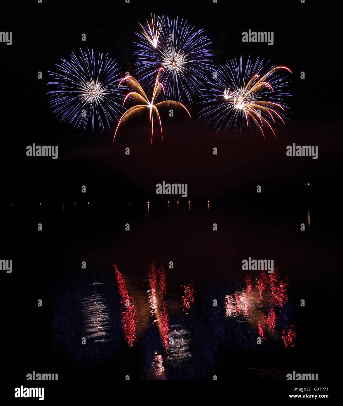 Colorful fireworks with reflection on lake and night sky in background ...