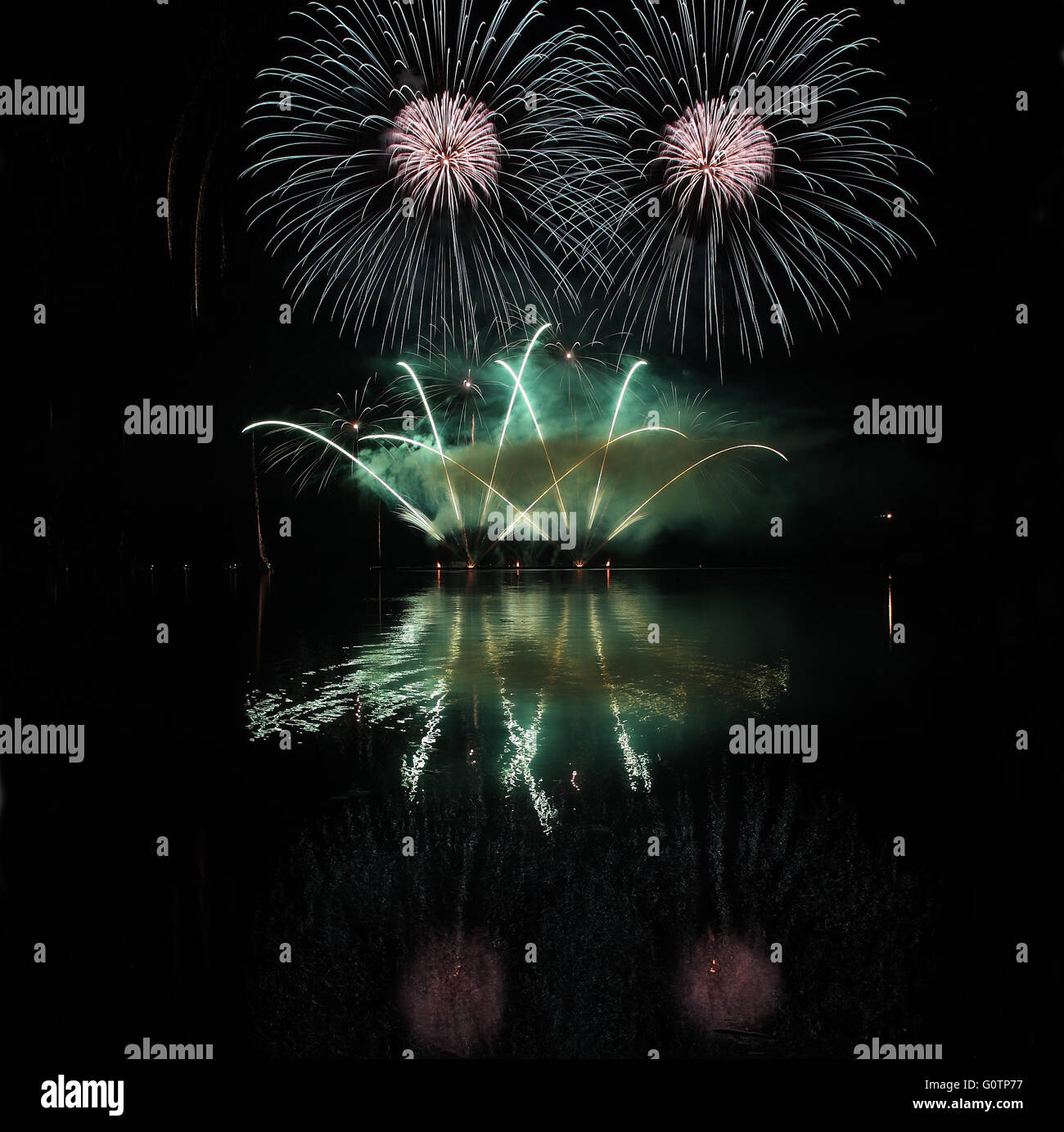 Colorful fireworks with reflection on lake and night sky in background ...