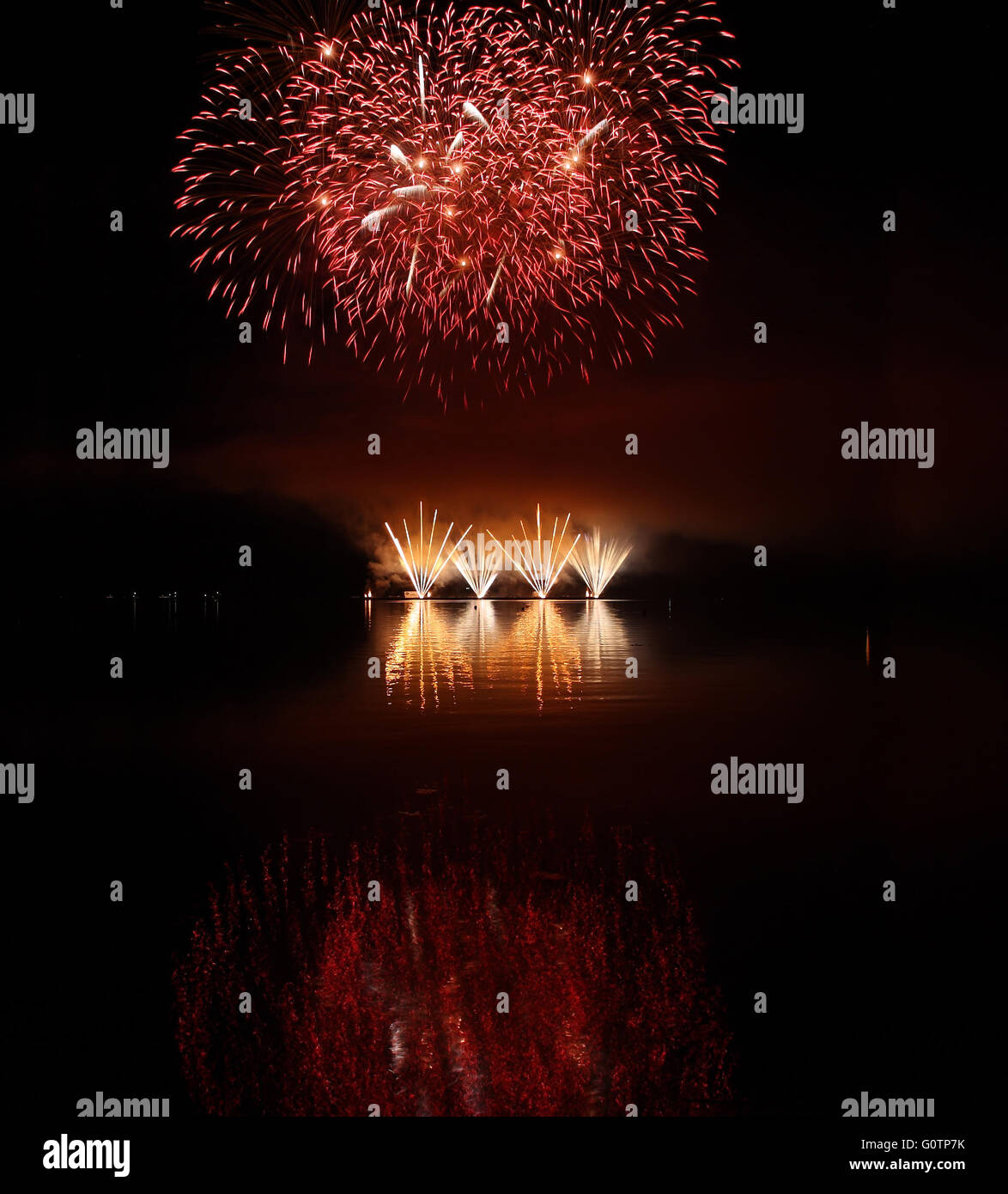 Colorful fireworks with reflection on lake and night sky in background ...