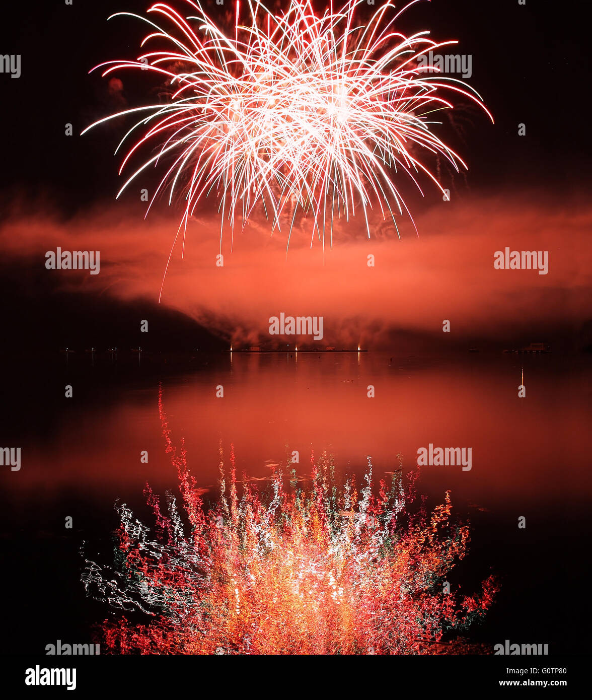 Colorful fireworks with reflection on lake and night sky in background ...