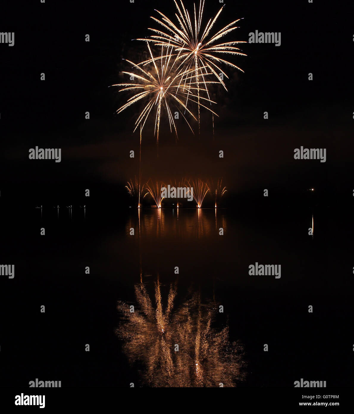 Colorful fireworks with reflection on lake and night sky in background ...