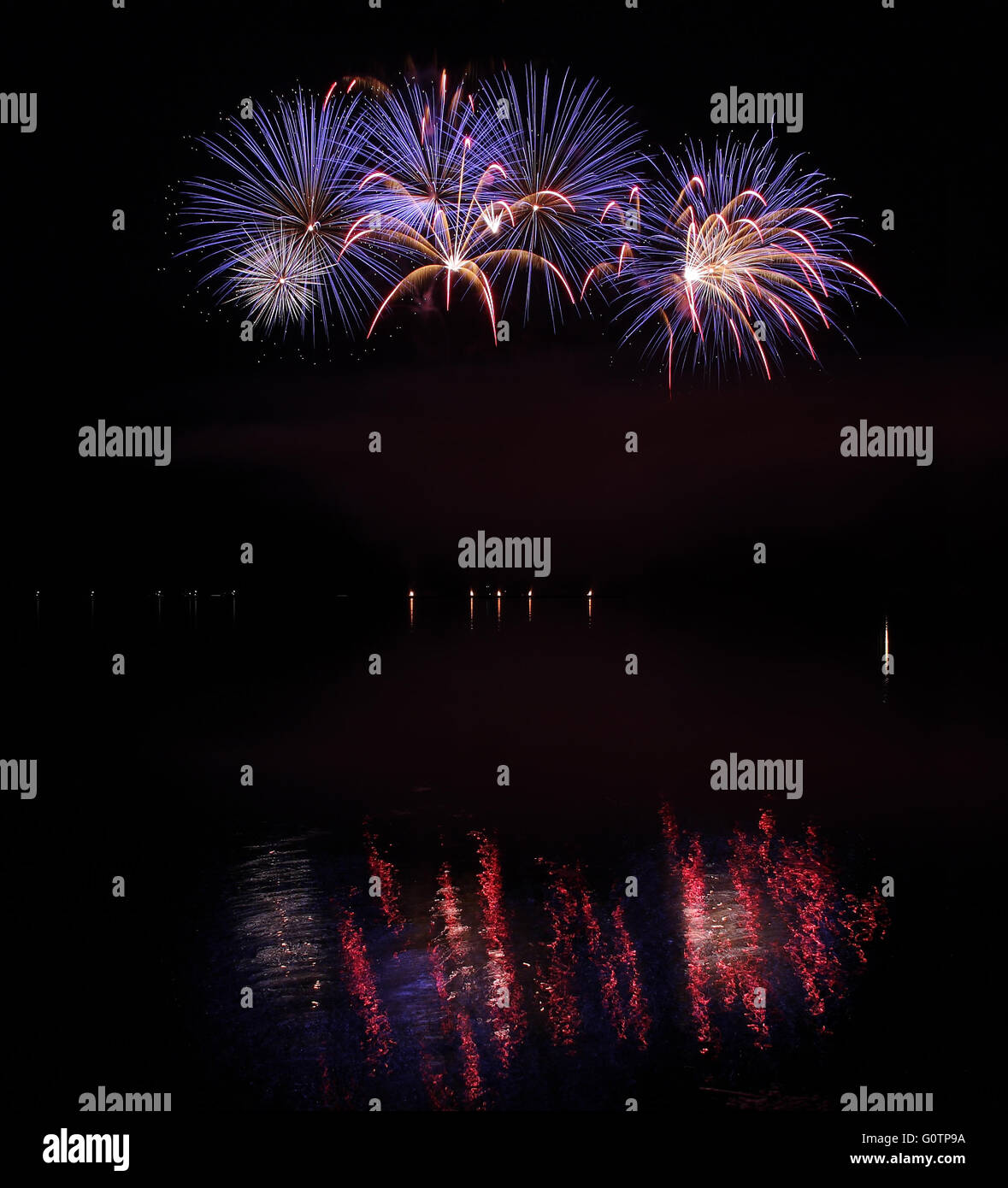 Colorful fireworks with reflection on lake and night sky in background ...