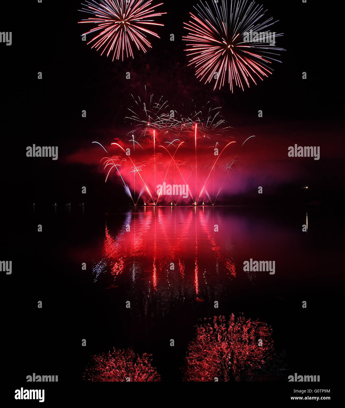 Colorful fireworks with reflection on lake and night sky in background ...