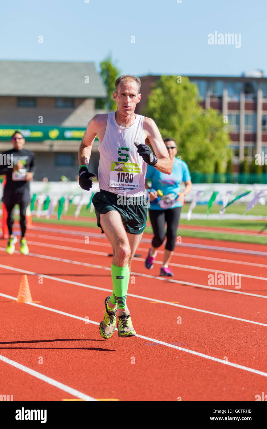 EUGENE, OR - MAY 1, 2016: Runner approaching the finish line on the ...