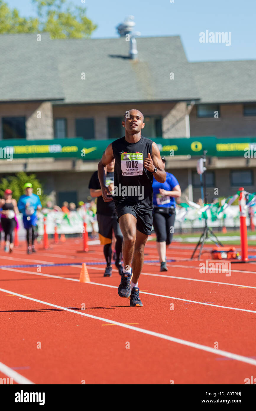 EUGENE, OR - MAY 1, 2016: Runner approaching the finish line on the ...