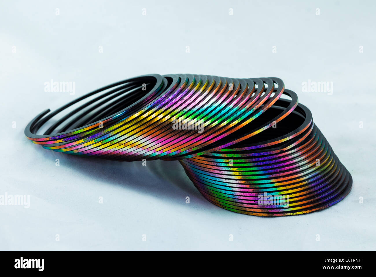 One colorful slinky toy with it different colors Stock Photo - Alamy