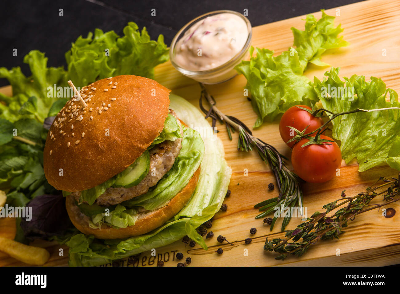 Concept: healthy food. Gourmet homemade burger with garnish and ...