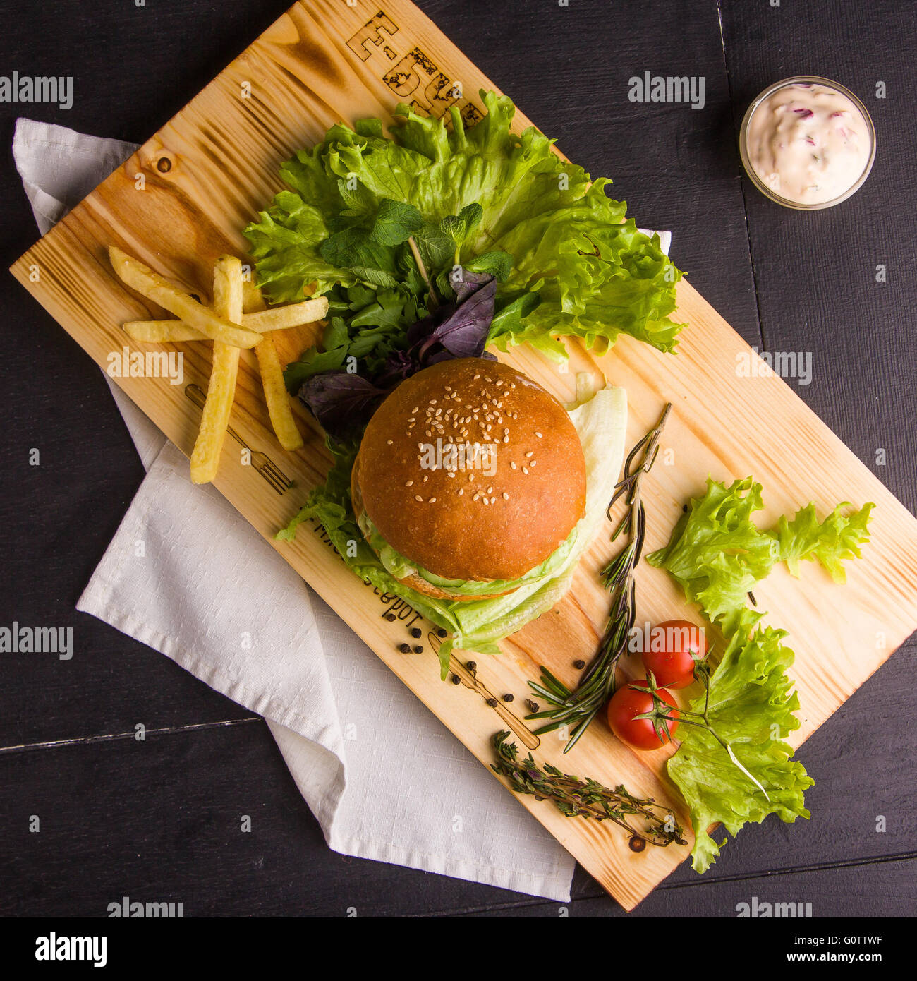Concept: healthy food. Gourmet homemade burger with garnish and ...
