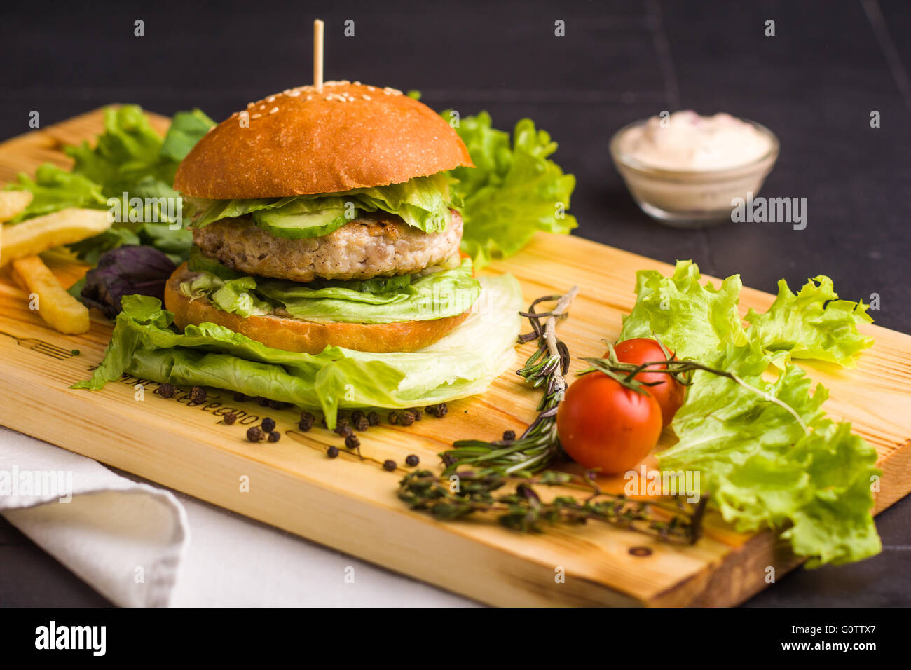 Concept: healthy food. Gourmet homemade burger with garnish and ...