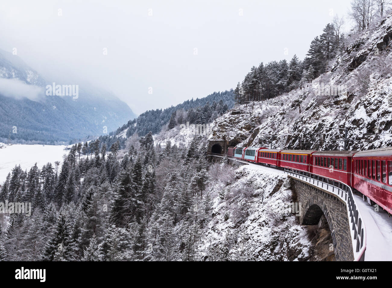 Famous sightseeing train in Switzerland, the Glacier Express in winter ...