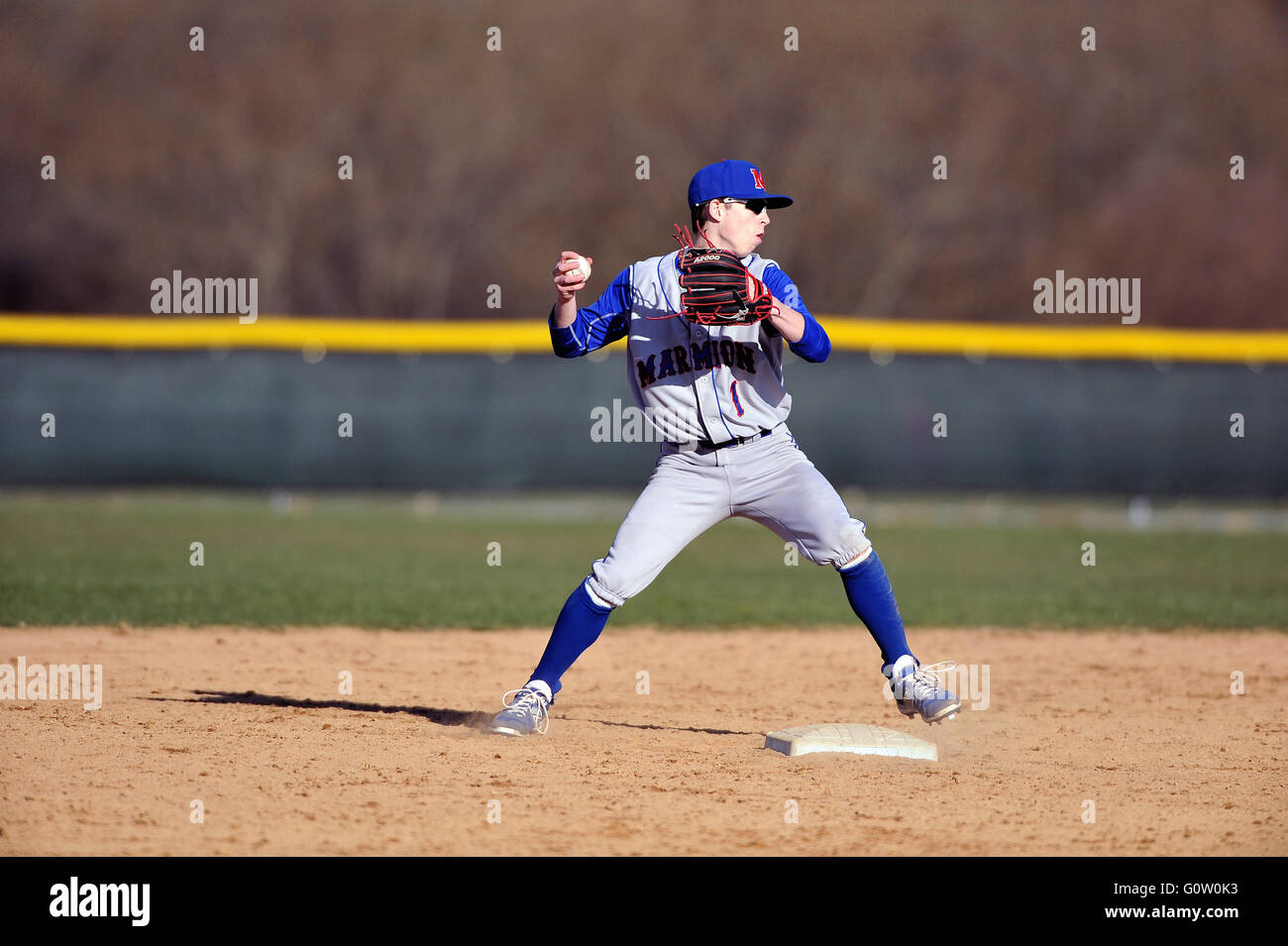 High school second baseman at second base accepting a throw before ...