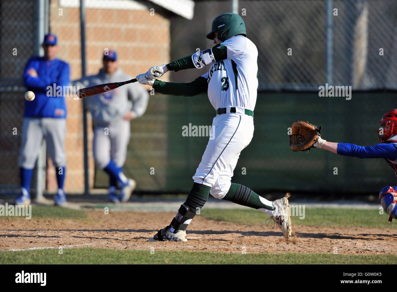 A hitter follows through on his swing after making contact with a pitch ...