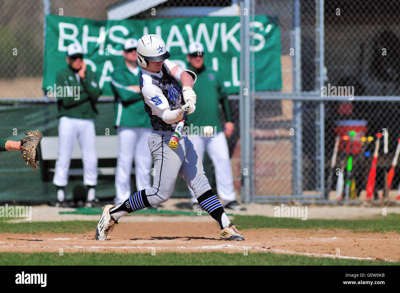 A hitter follows through on his swing while making contact with a pitch ...