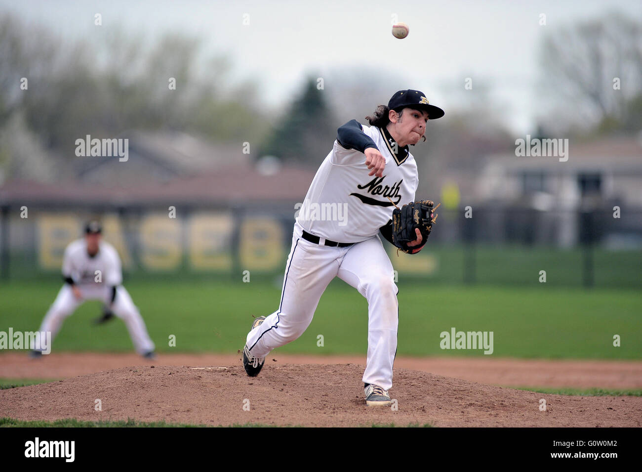 Right-handed pitcher delivering a pitch to a waiting hitter during a ...