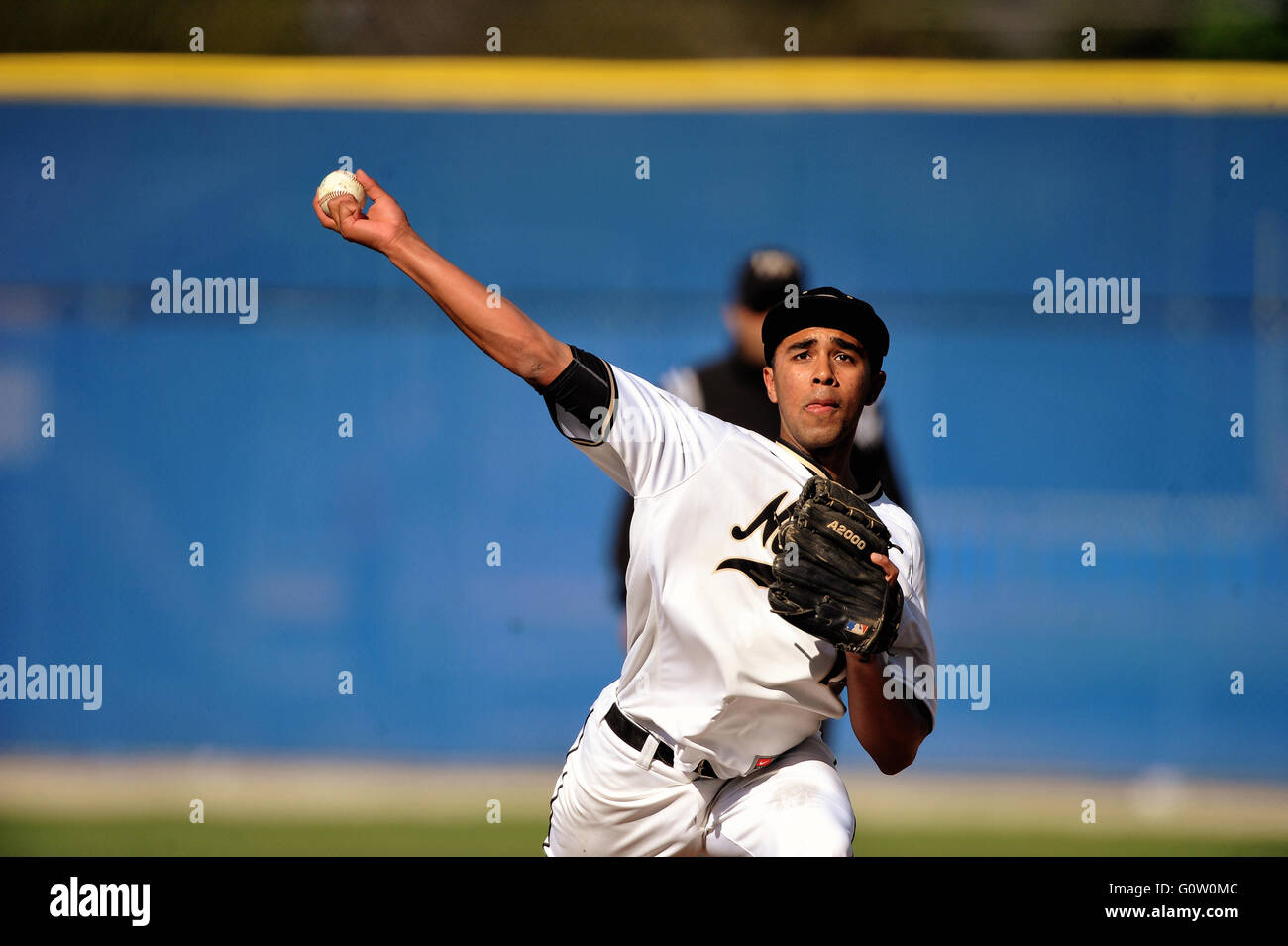 Right-handed pitcher delivering a pitch to a waiting hitter during a ...