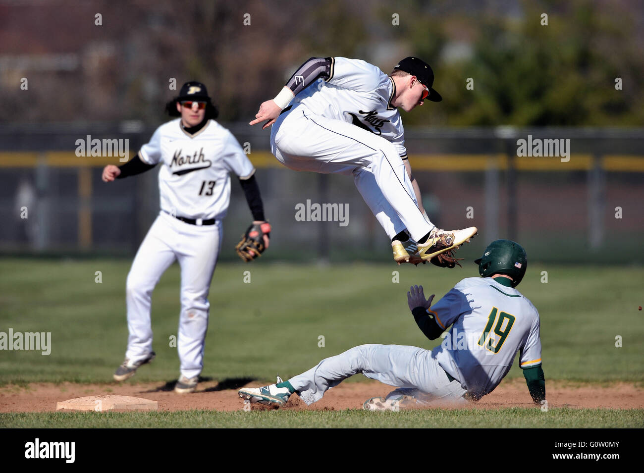 After snagging a high throw, an airborne shortstop attempting to apply ...