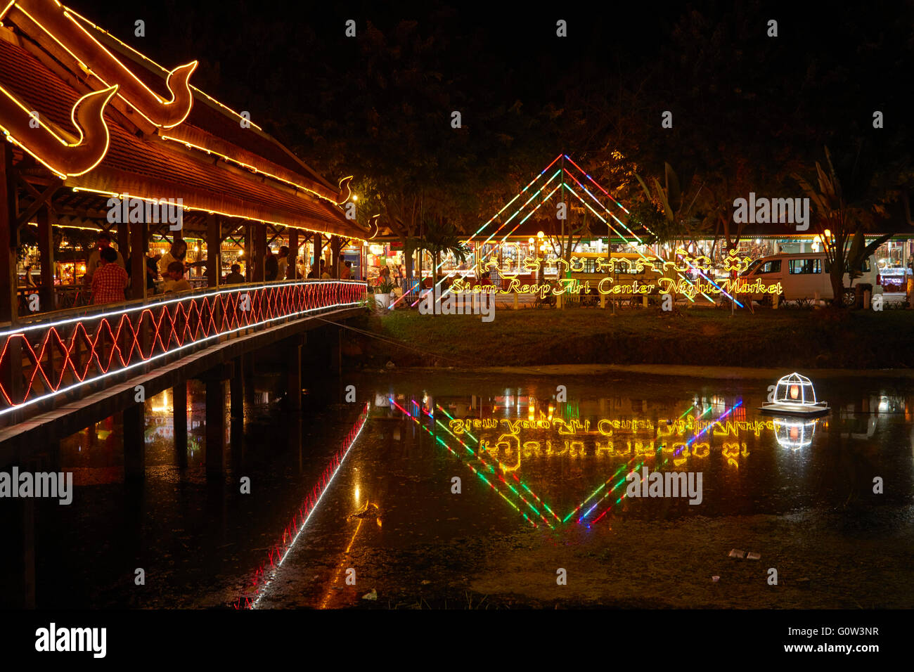 Lights On Covered Pedestrian Bridge Over Siem Reap River And Art