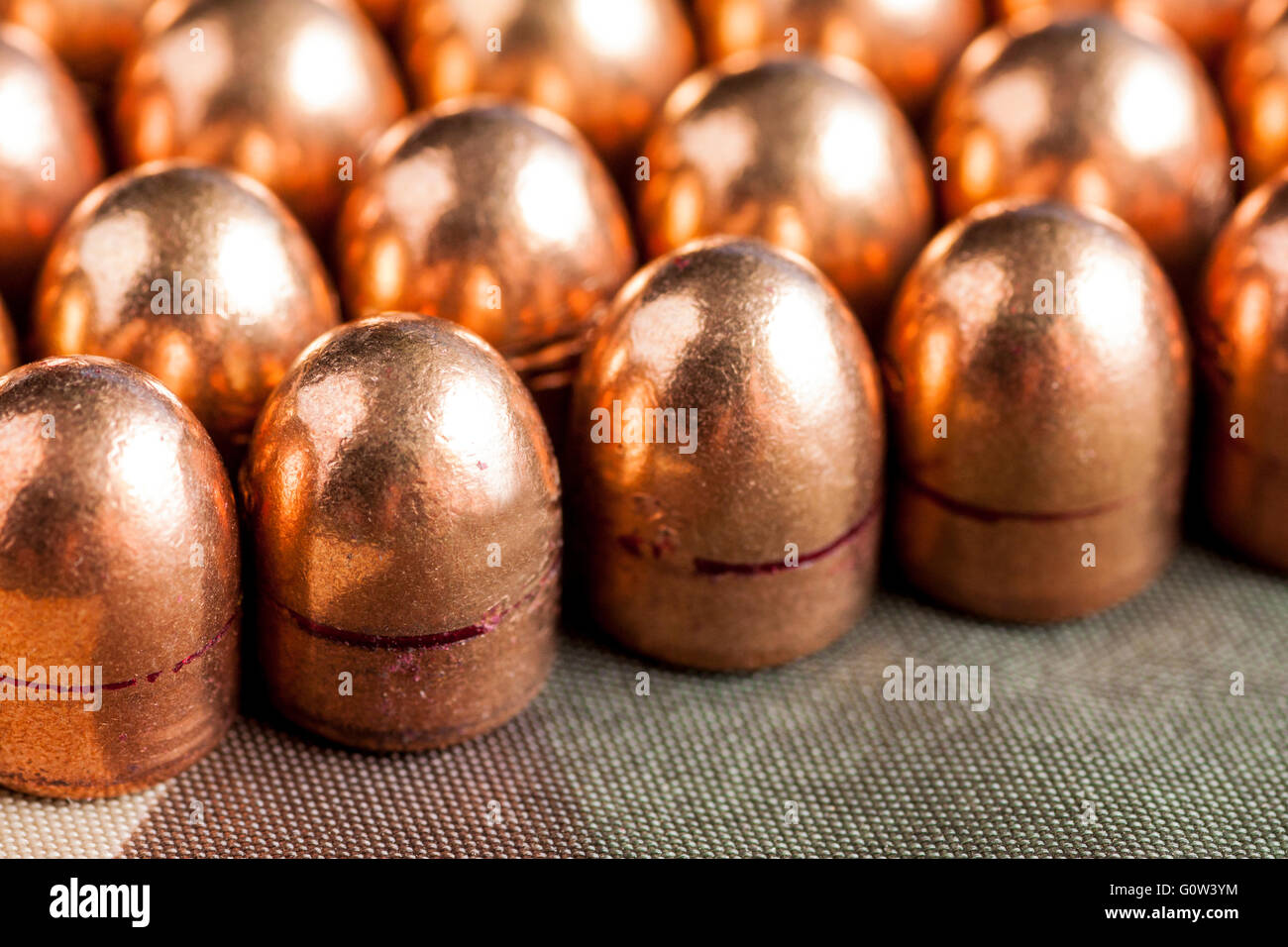 bullets on camouflage background spill out of the banks on camouflage ...