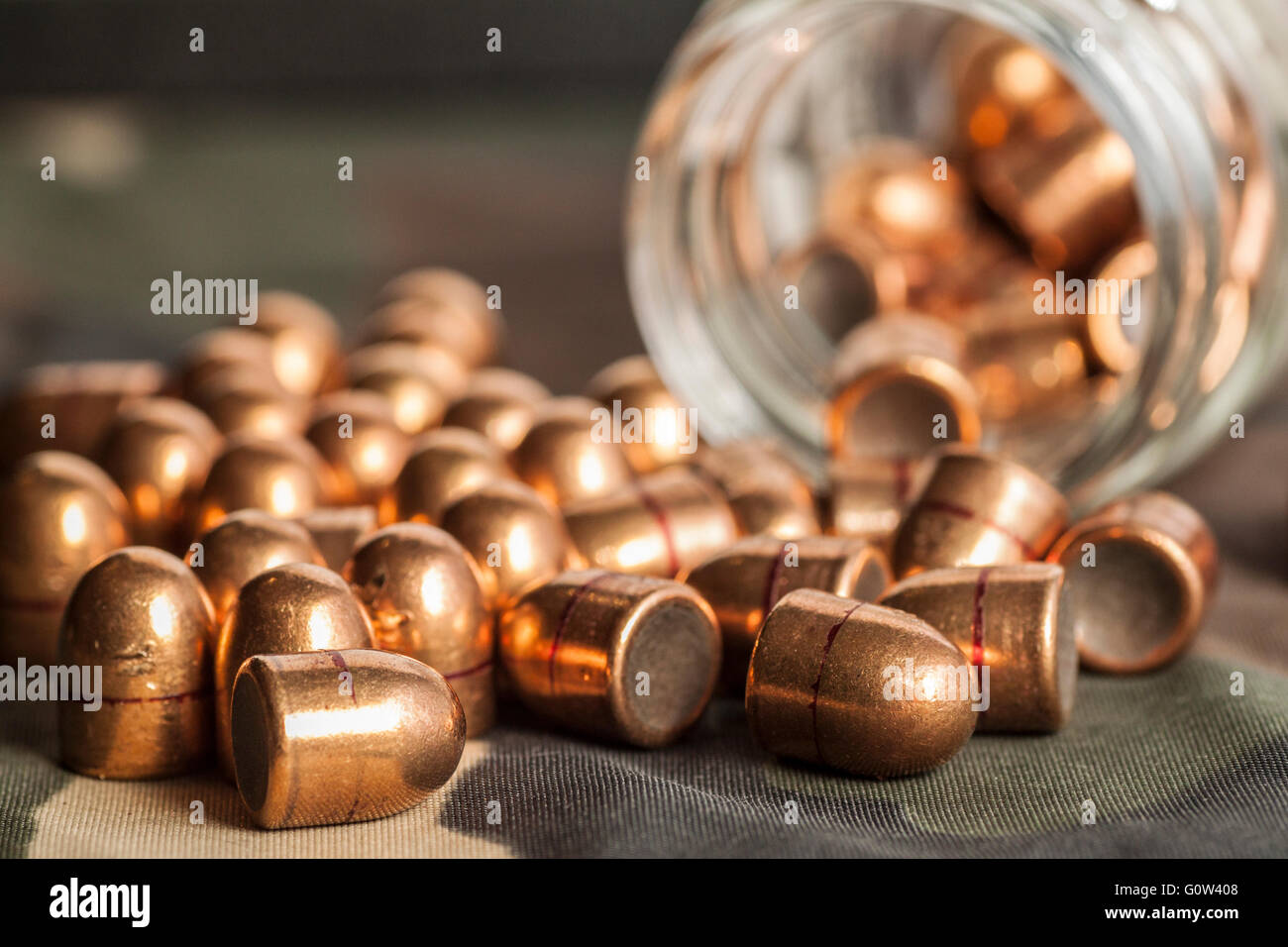 bullets on camouflage background spill out of the banks on camouflage ...