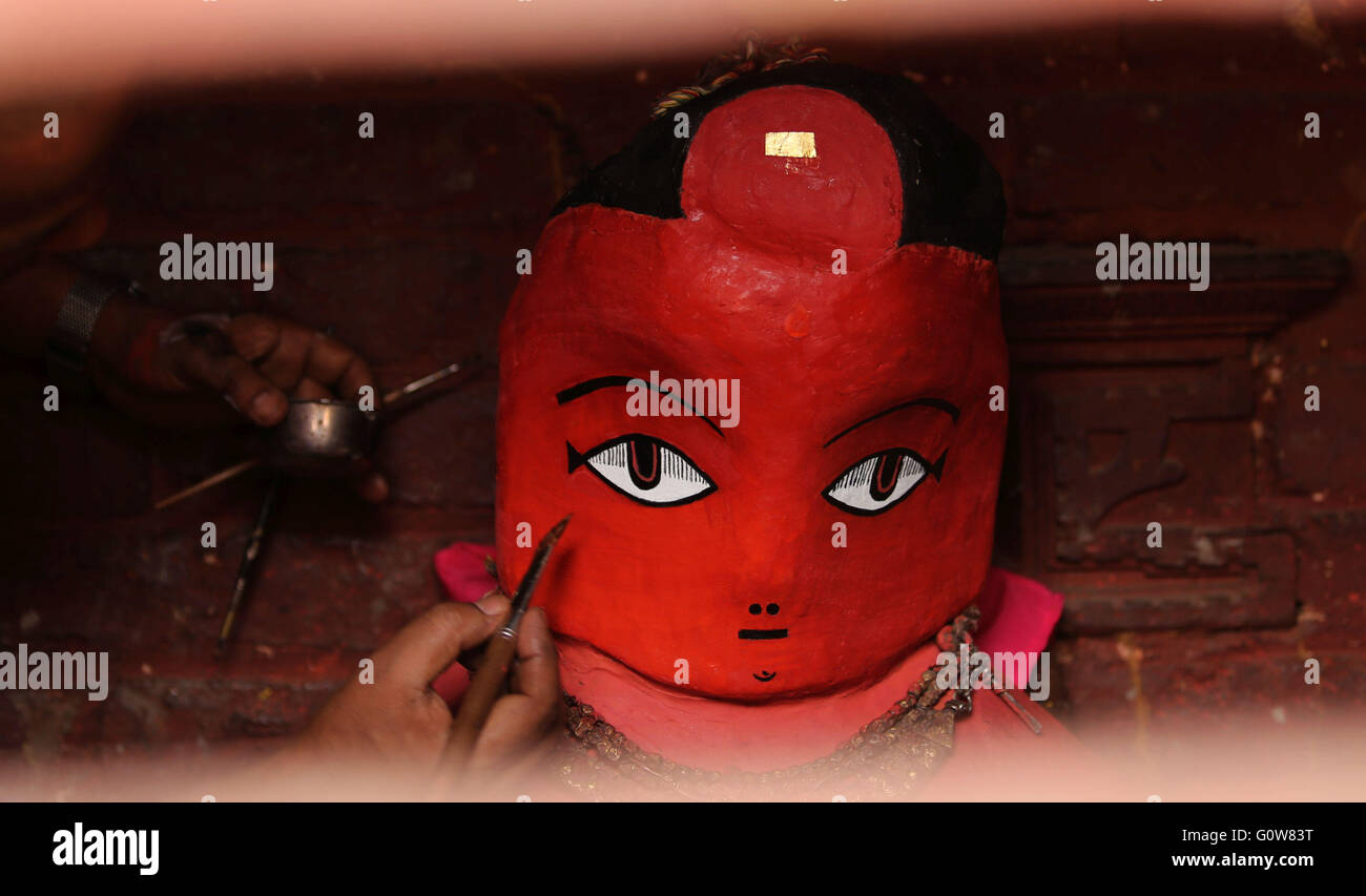 A priest gives a final touch to the idol of Rato Machhendranath, the ...