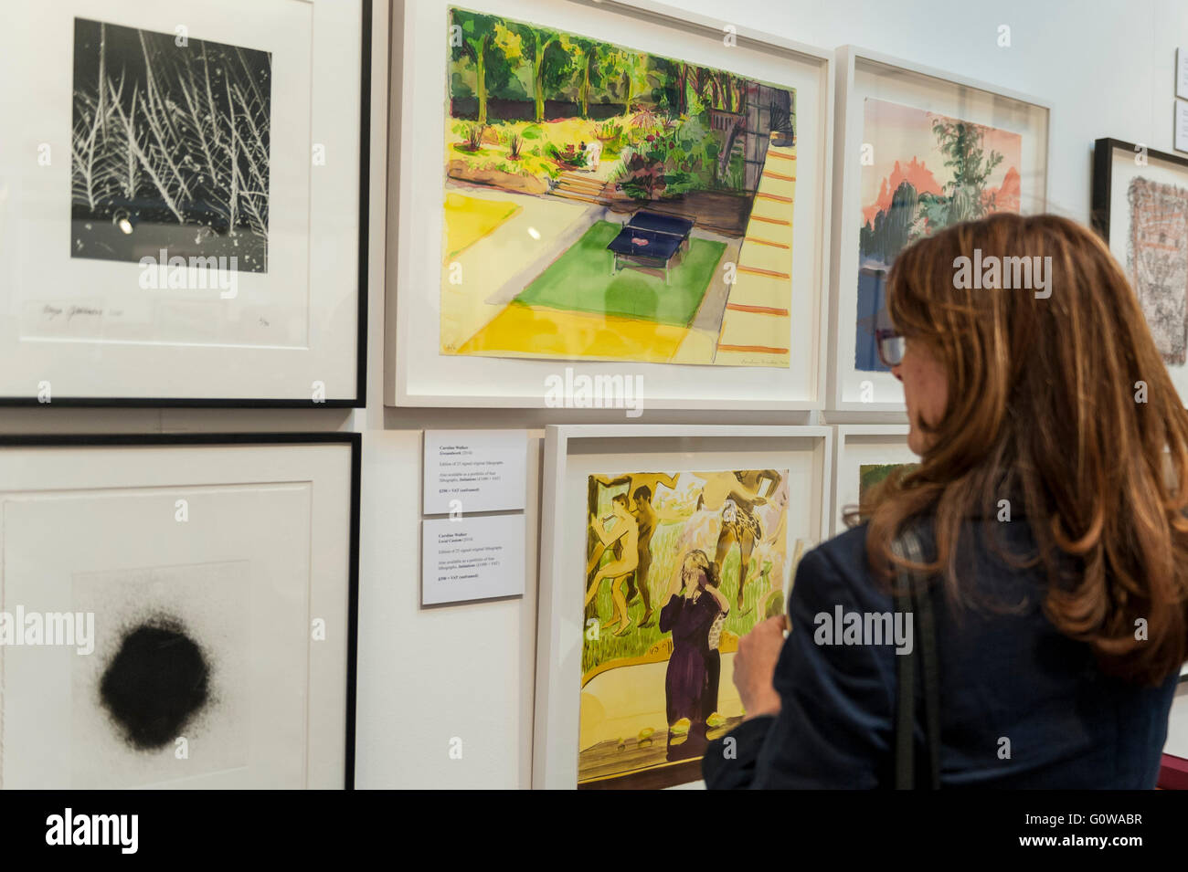 London, UK. 4 May 2016. A visitor views prints on display at the ...